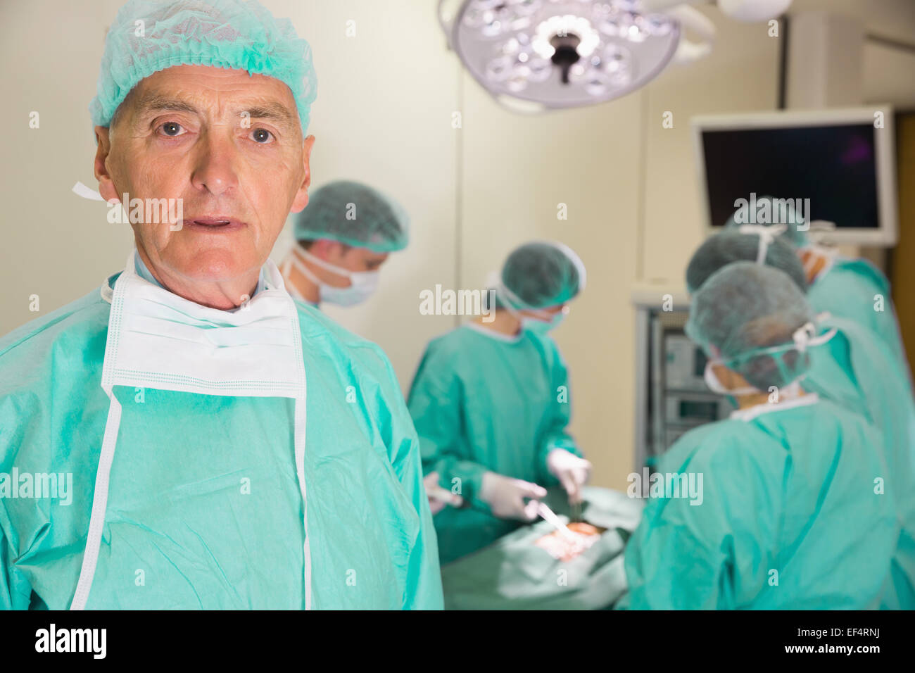Medical professor looking at camera during fake surgery Stock Photo - Alamy