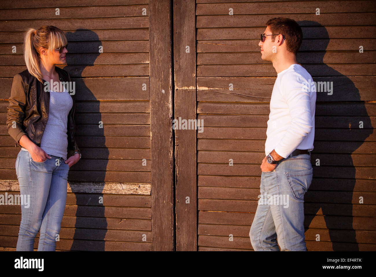 Young couple leaning against wooden gate Stock Photo - Alamy Young couple leaning against wooden gate Stock Photo - Alamy