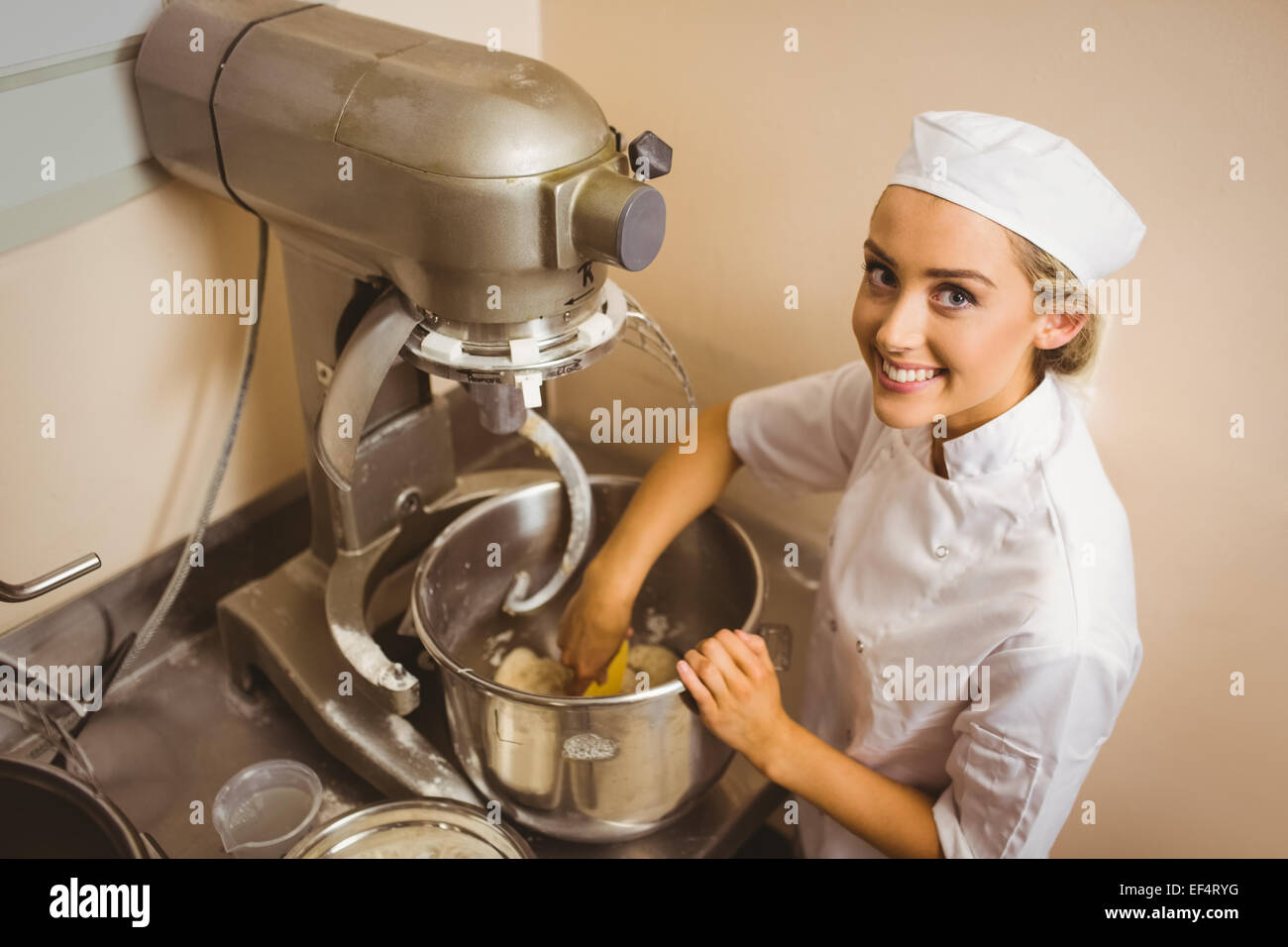 Baker using large mixer to mix dough Stock Photo - Alamy