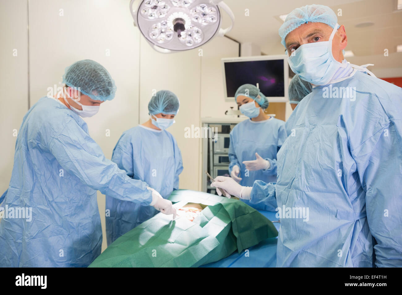 Medical student looking at camera during practice surgery Stock Photo ...