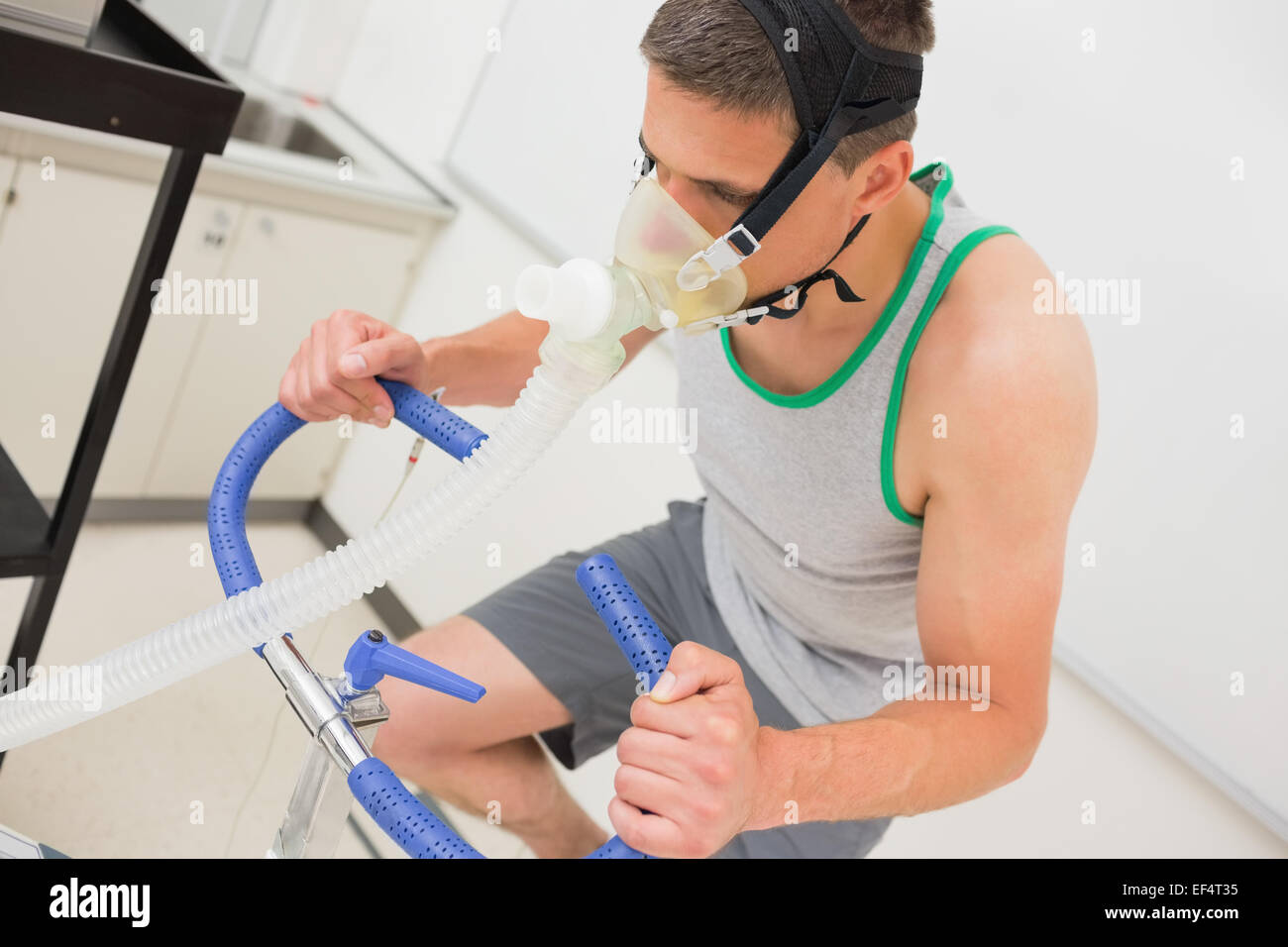 Man doing fitness test on exercise bike Stock Photo - Alamy