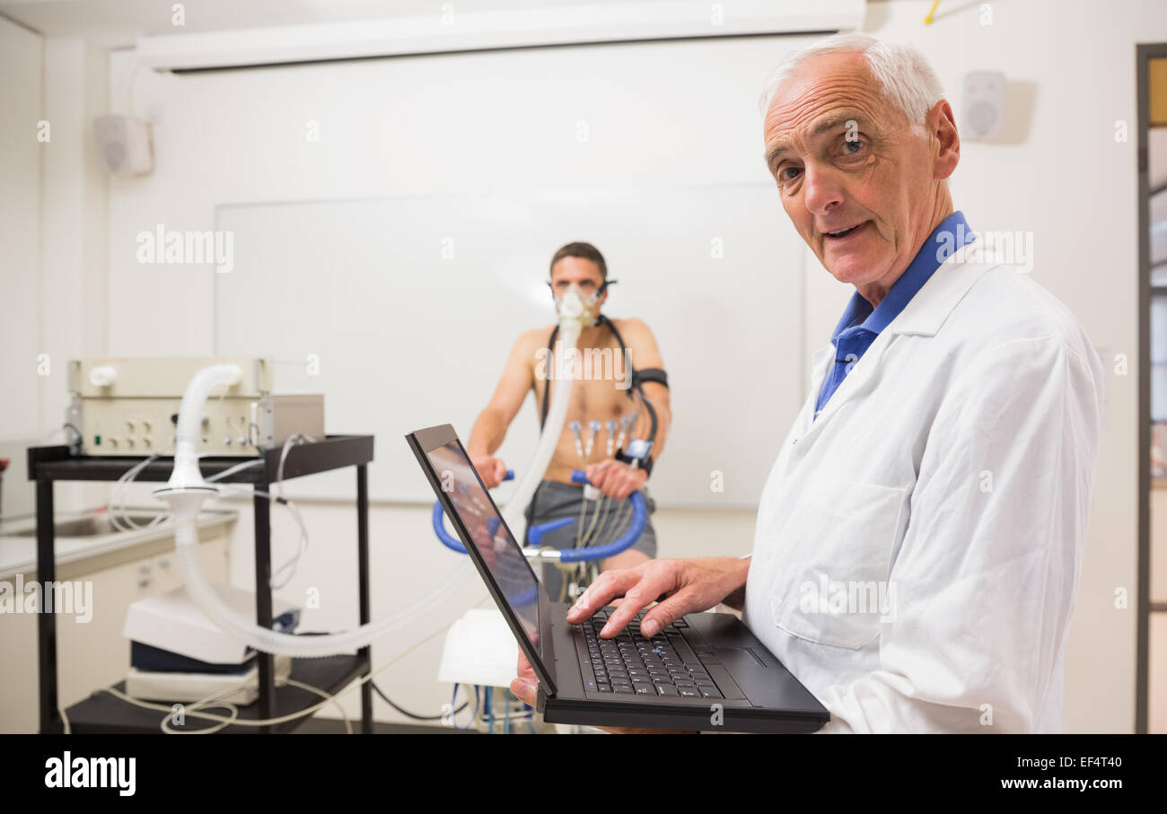 Doctor conducting fitness test smiling at camera Stock Photo - Alamy