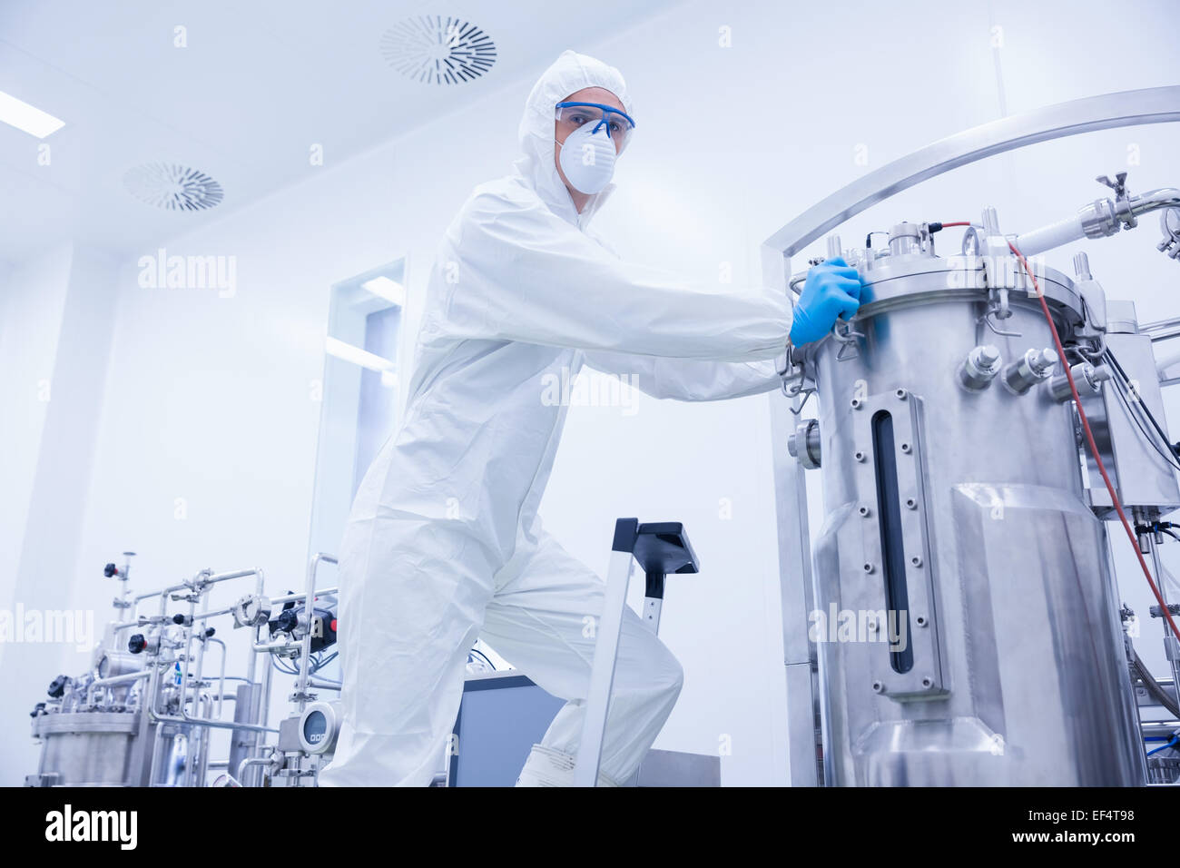 Scientist standing on ladder looking at the camera Stock Photo - Alamy