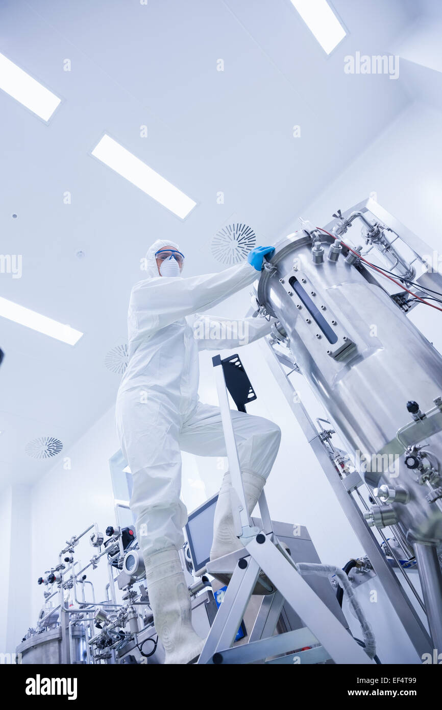 Scientist standing on ladder looking at the camera Stock Photo - Alamy