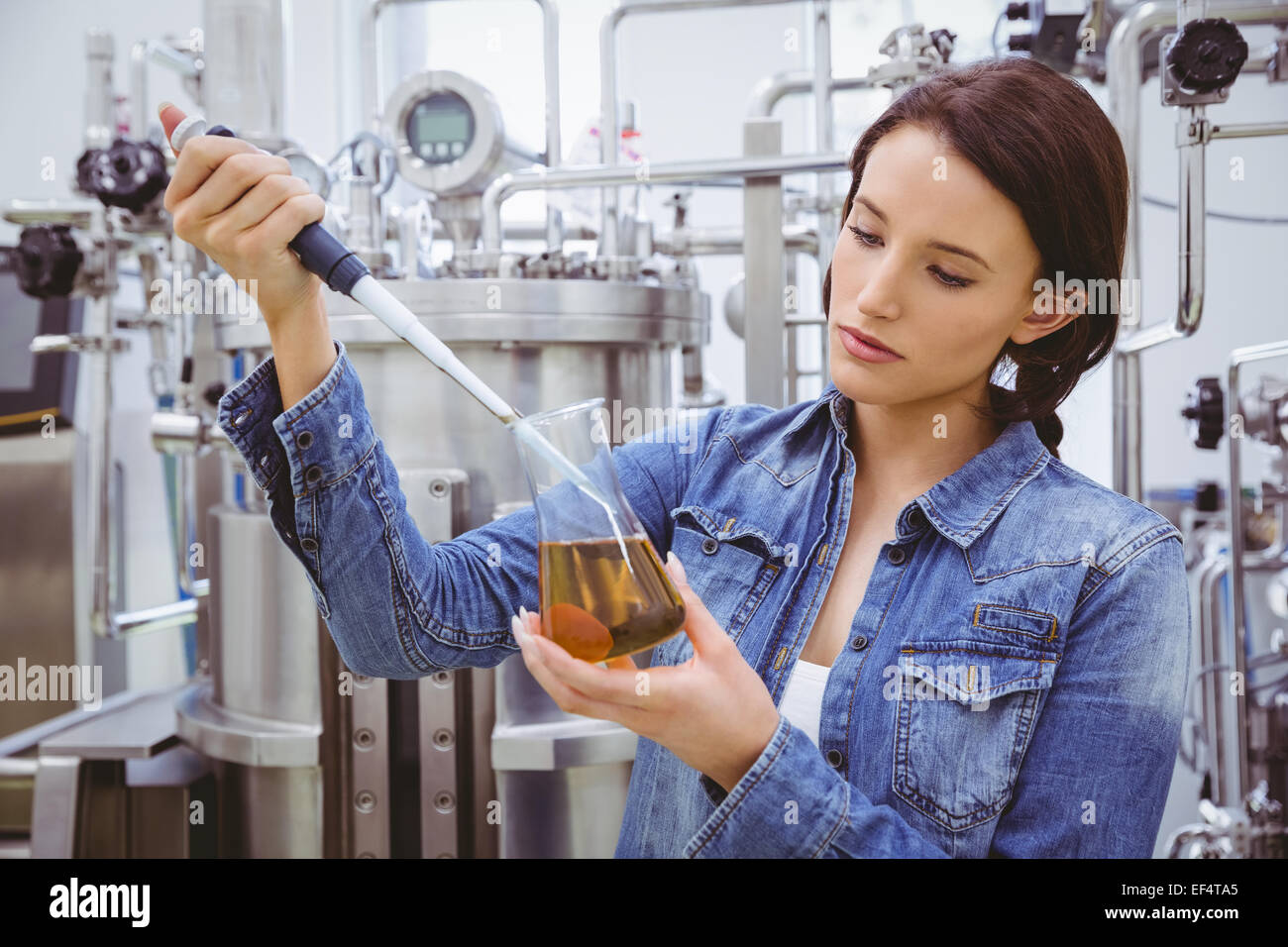 Scientist preparing an experiment with a pipette and beaker Stock Photo ...
