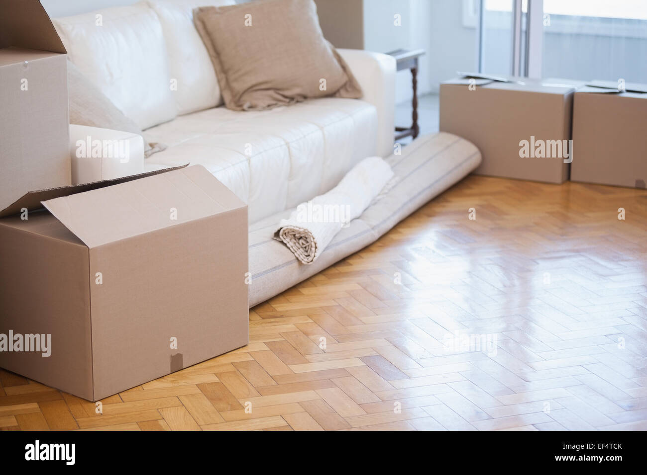 Rolled up carpet and boxes Stock Photo - Alamy