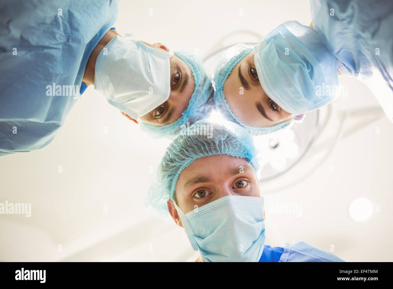 Young surgeons looking down at camera Stock Photo - Alamy