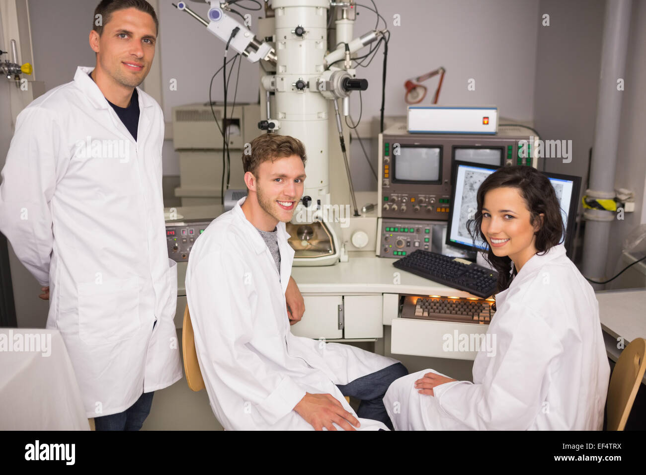 Biochemistry students using large microscope and computer Stock Photo ...