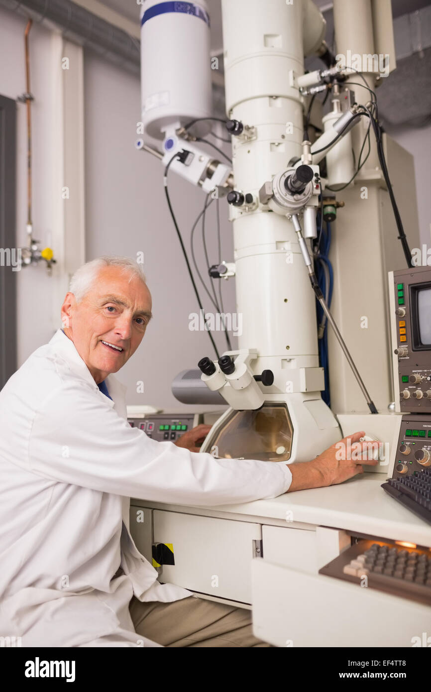 Biochemist using large microscope and computer Stock Photo - Alamy