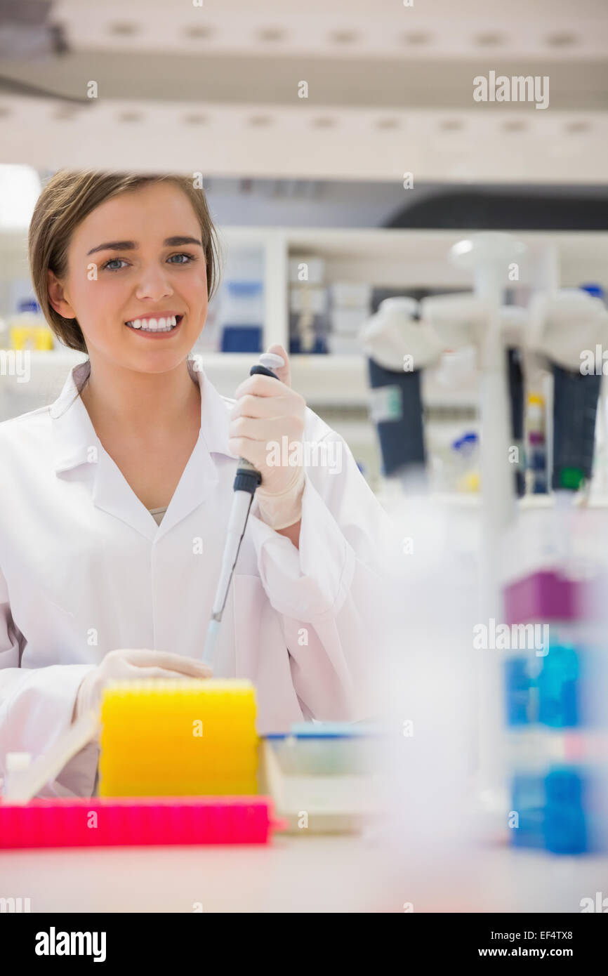 Pretty science student using pipette Stock Photo - Alamy
