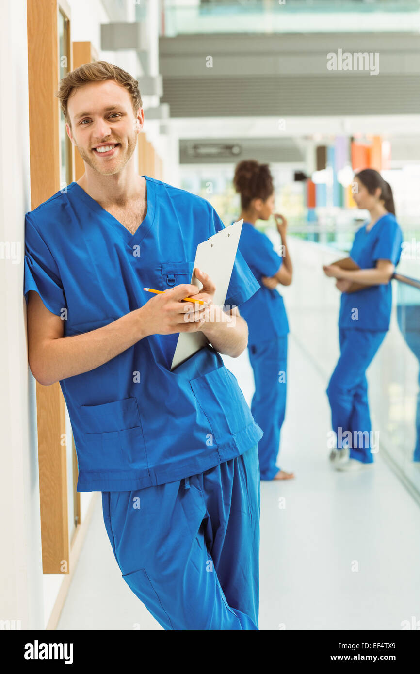Medical student smiling at camera in hallway Stock Photo - Alamy