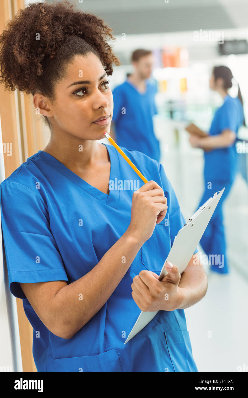 Medical student thinking in hallway Stock Photo - Alamy