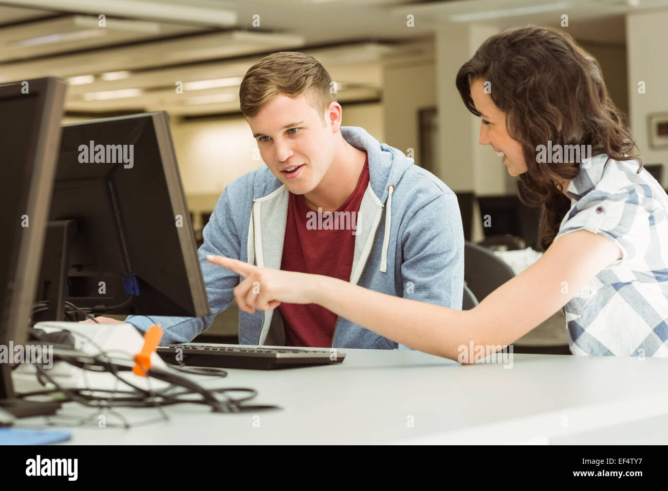 Classmates working together in the computer room Stock Photo - Alamy
