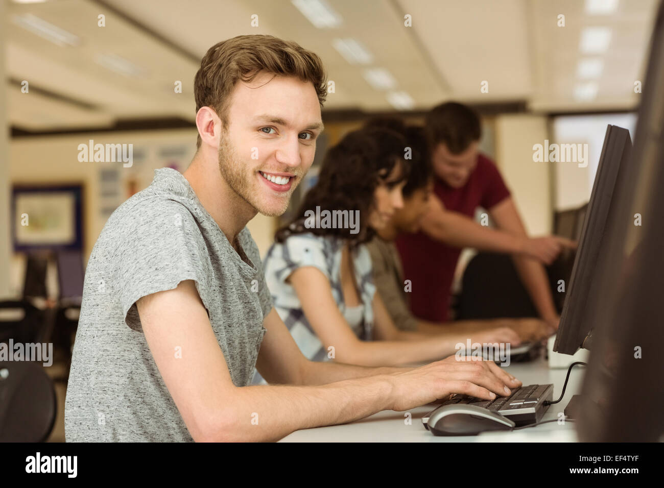 Classmates working in the computer room Stock Photo - Alamy