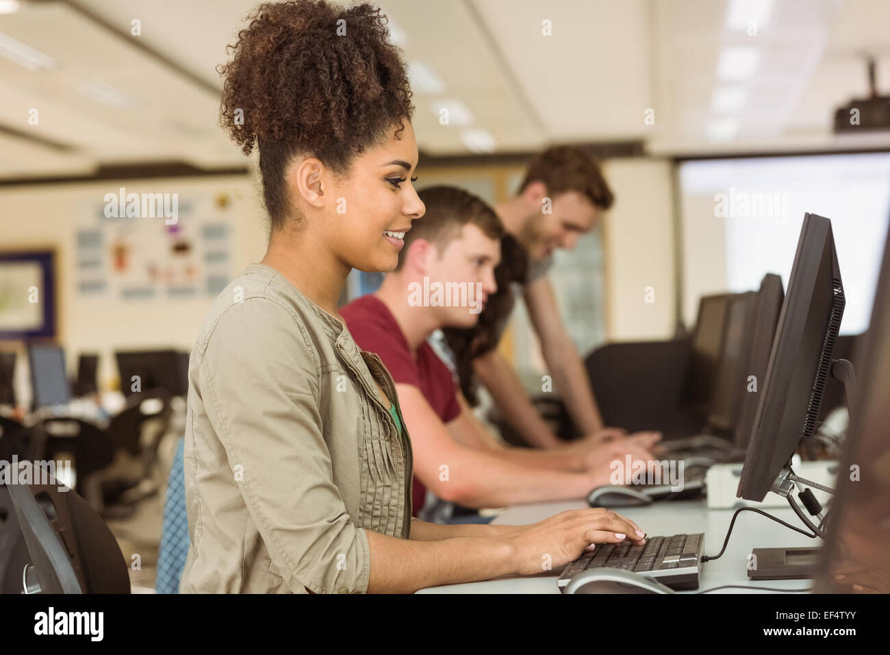 Classmates working in the computer room Stock Photo - Alamy