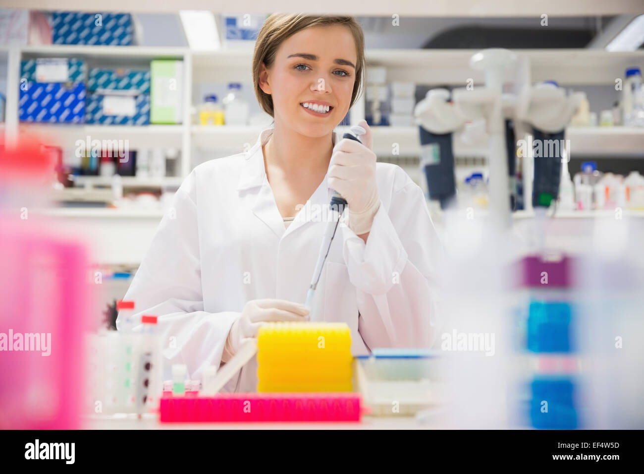 Pretty science student using pipette Stock Photo - Alamy