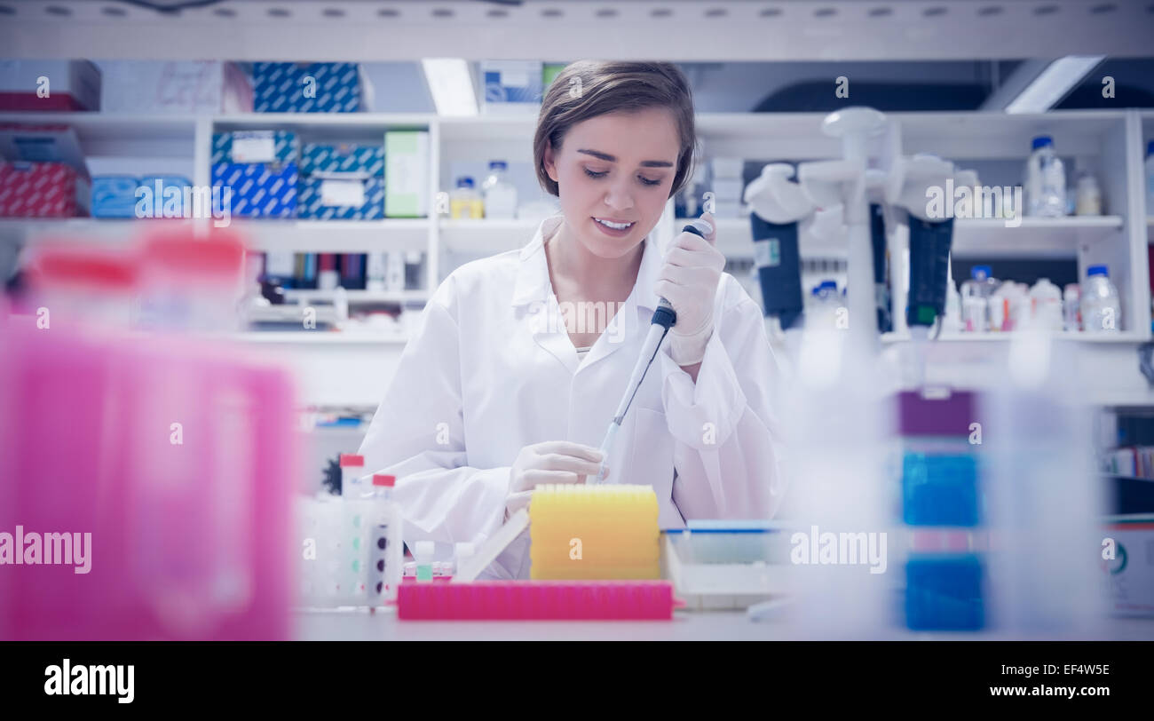Pretty science student using pipette Stock Photo - Alamy