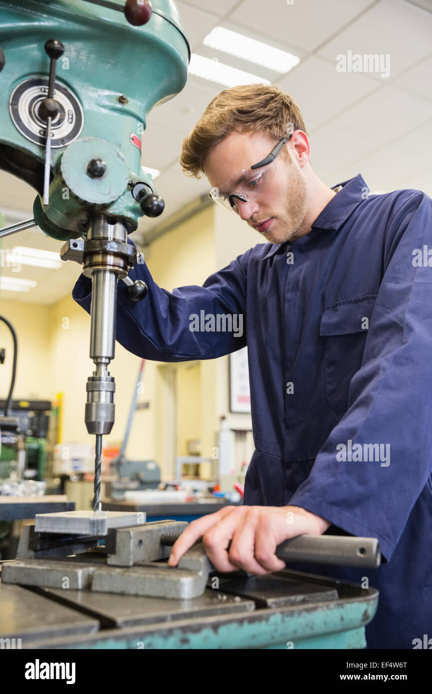 Engineering student using large drill Stock Photo - Alamy