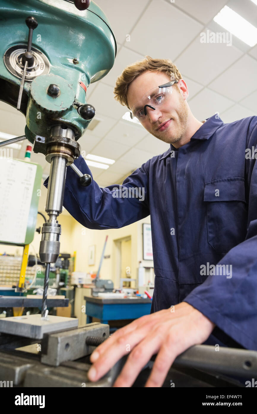 Engineering student using large drill Stock Photo - Alamy
