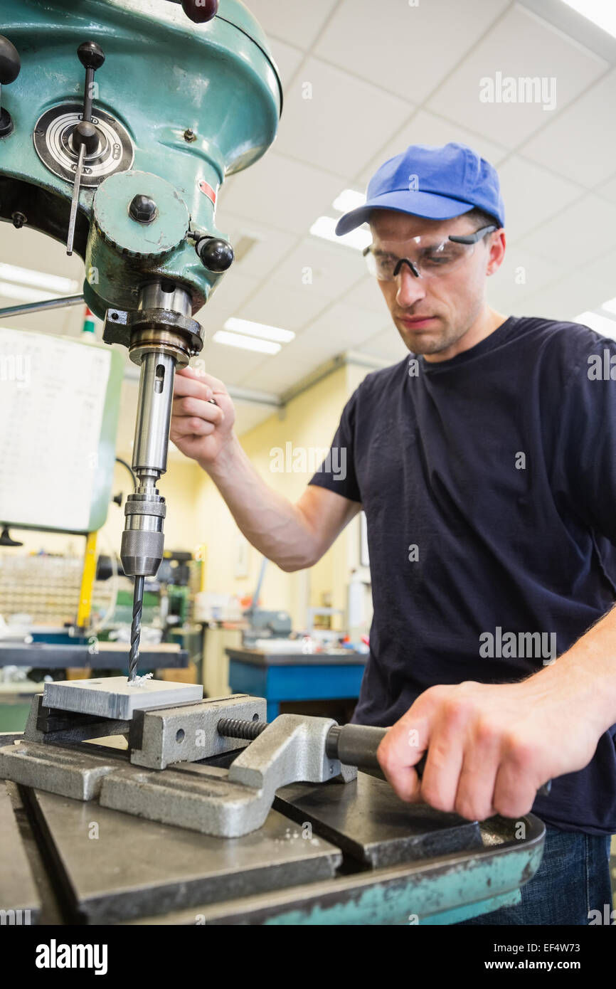 Engineering student using large drill Stock Photo - Alamy