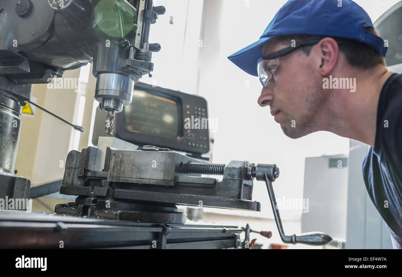 Engineering student using large drill Stock Photo - Alamy