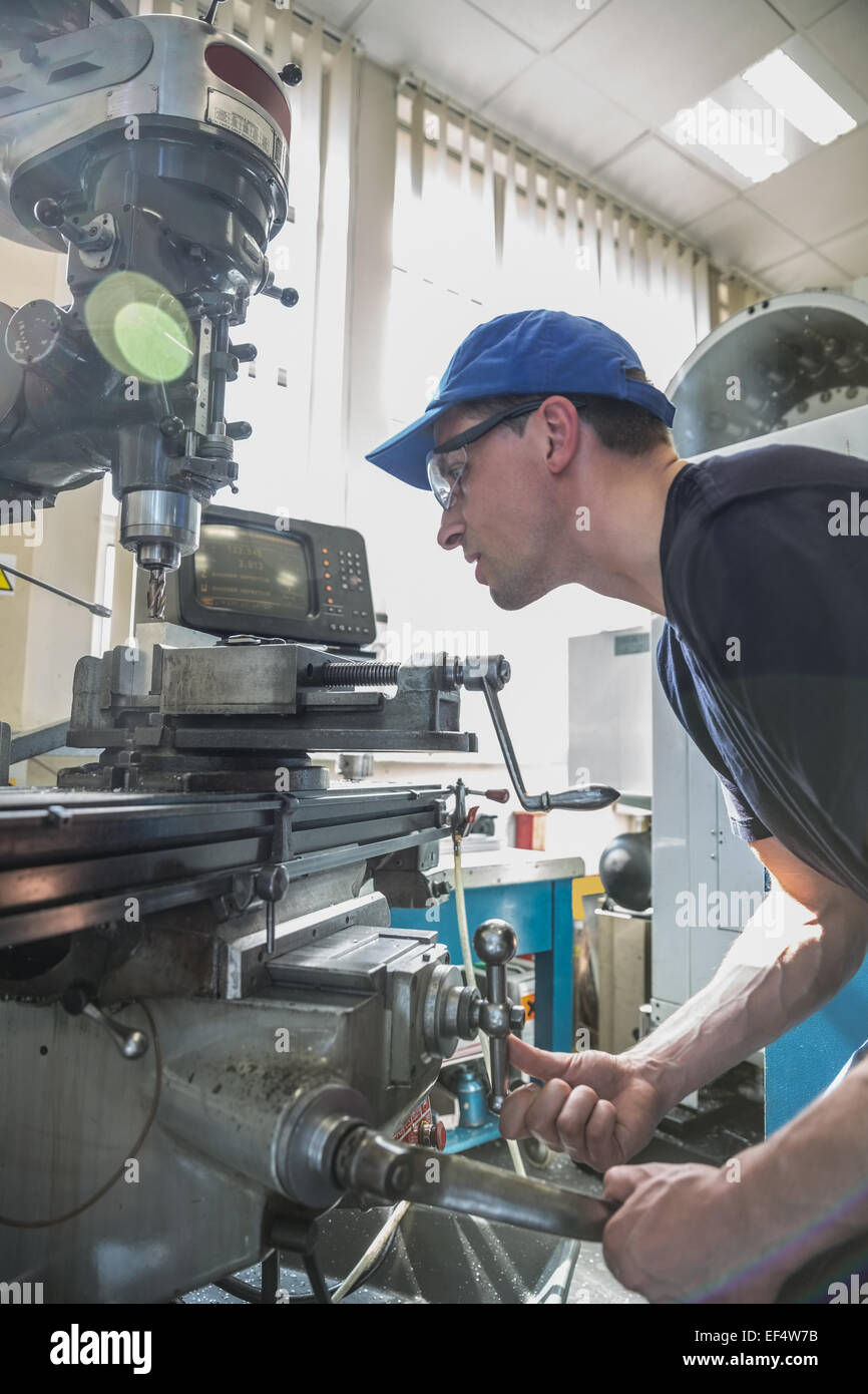 Engineering student using large drill Stock Photo - Alamy