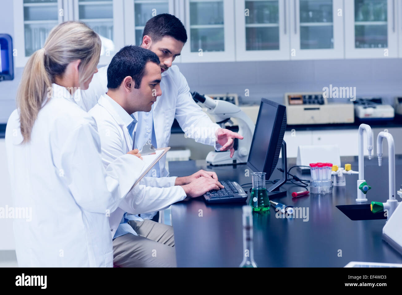 Students in laboratory using microscope hi-res stock photography and ...