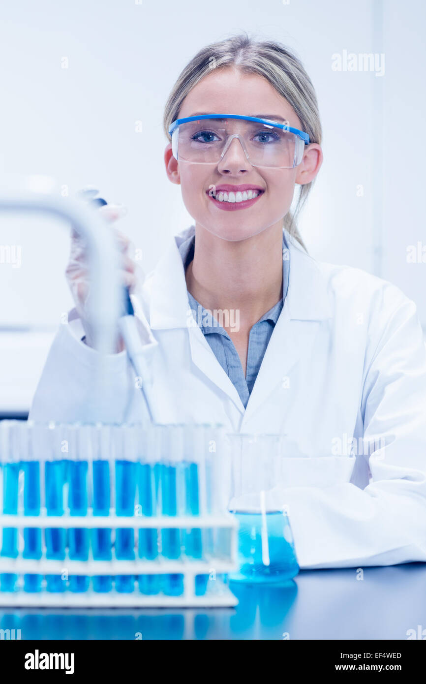 Science student using pipette in the lab Stock Photo - Alamy