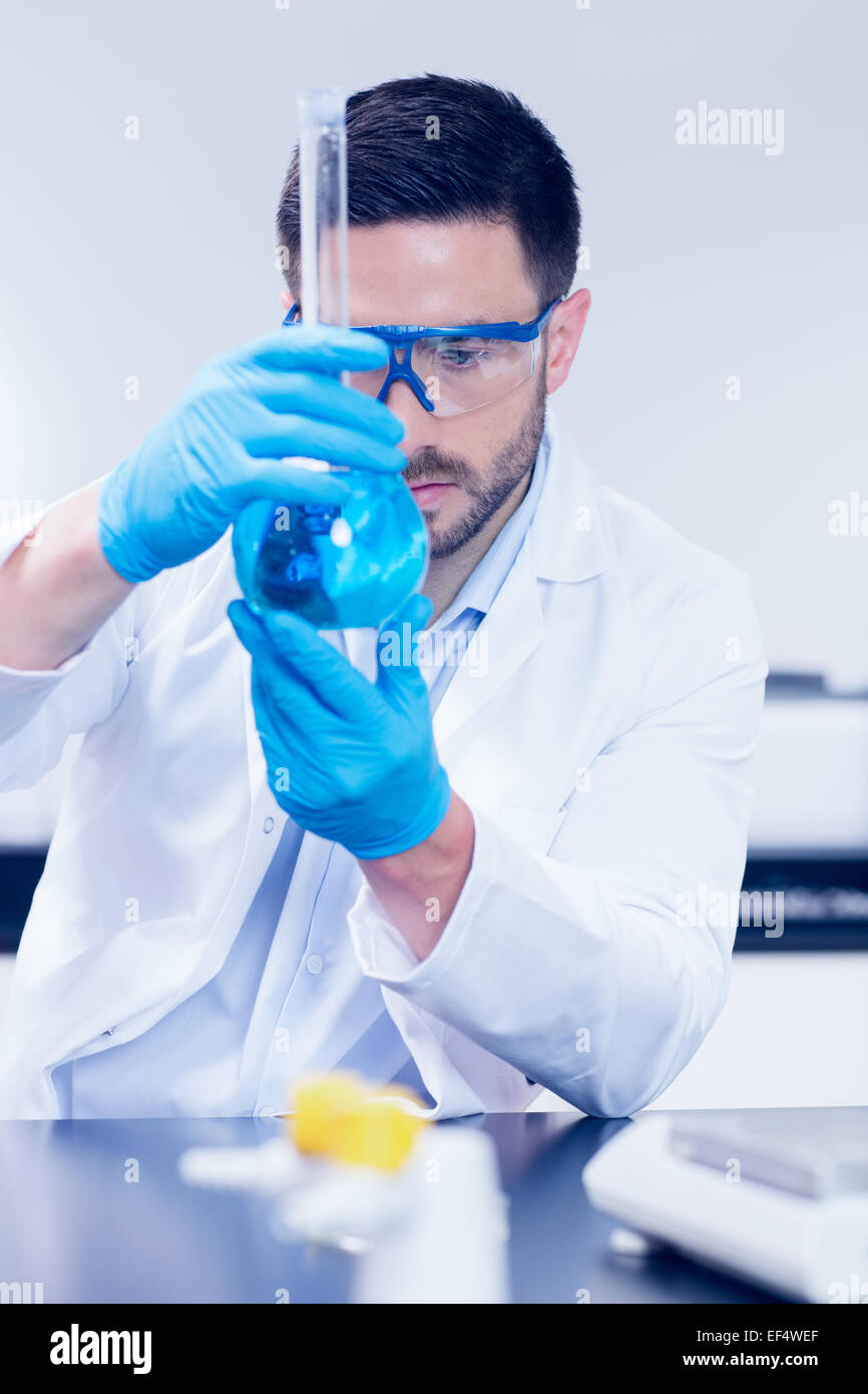 Science student looking at beaker Stock Photo - Alamy