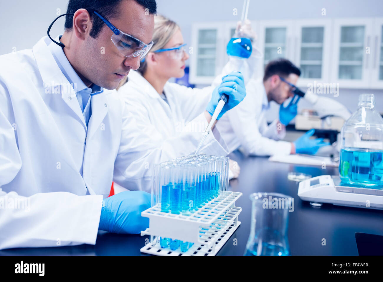Science student using pipette in the lab to fill test tubes Stock Photo ...
