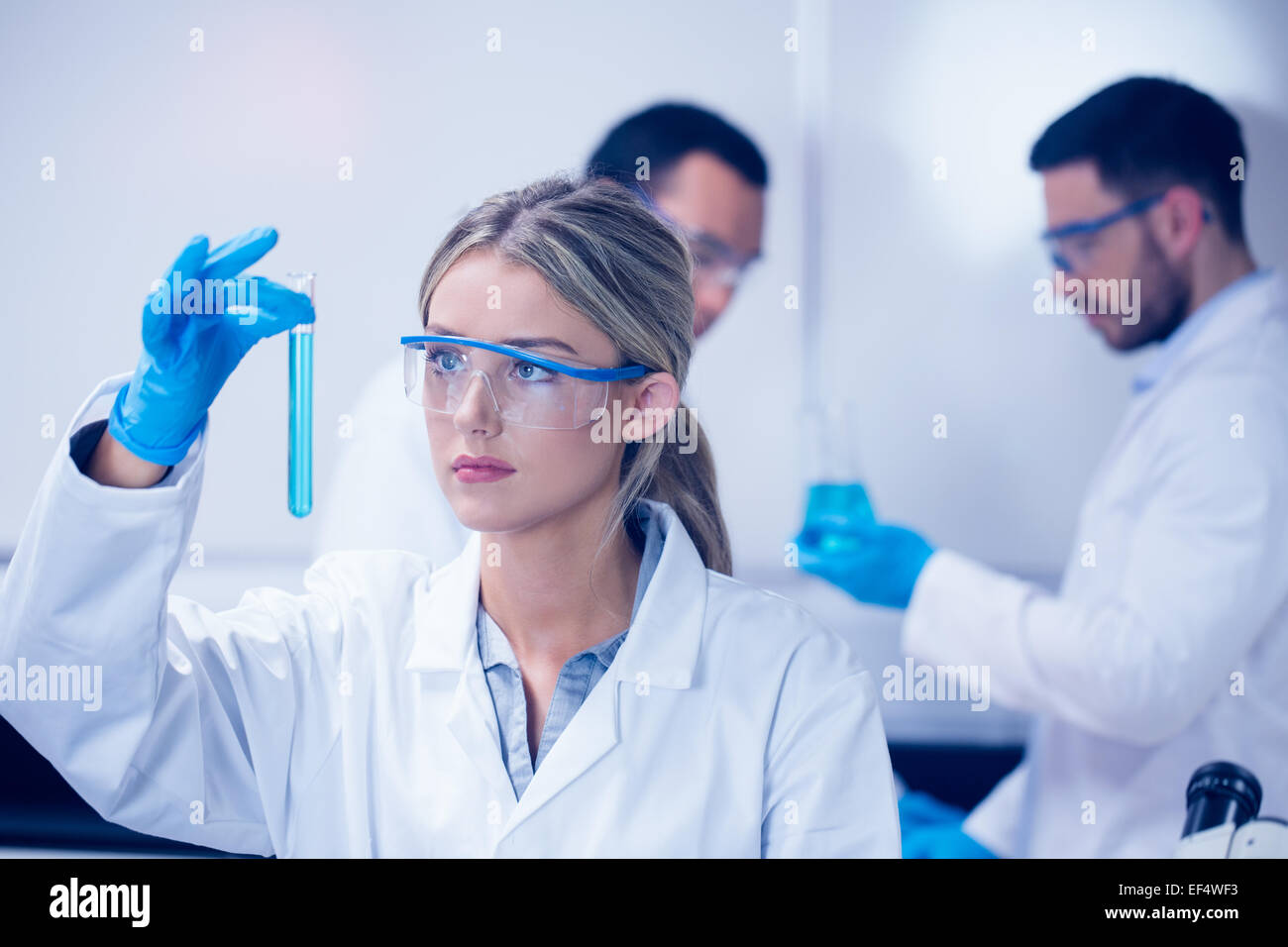 Science student holding up test tube Stock Photo - Alamy