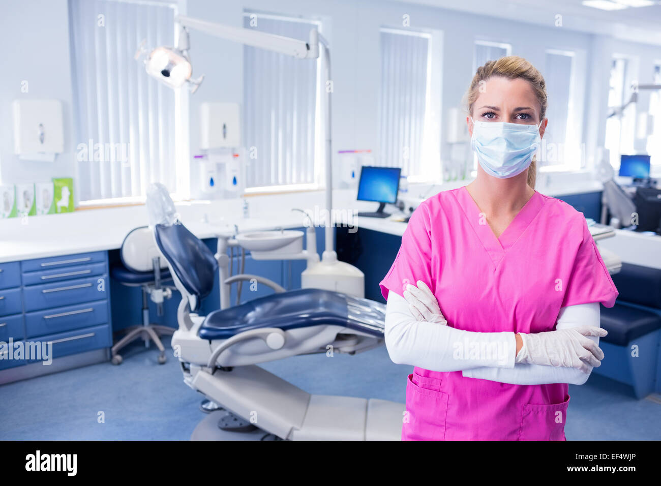 Dentist standing arms crossed in hi-res stock photography and images ...