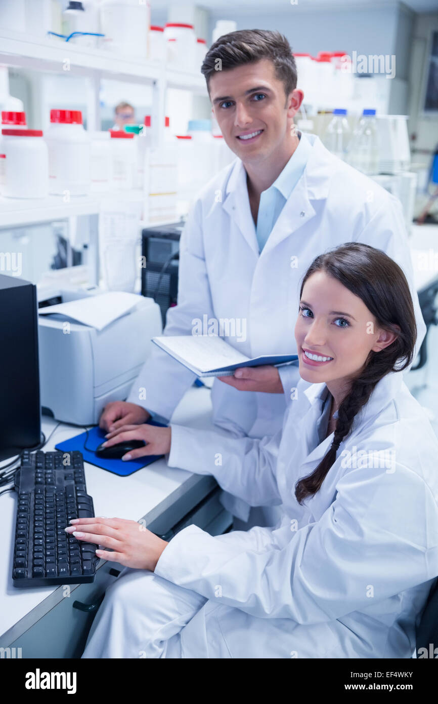 Chemist team working together at desk using computer Stock Photo - Alamy