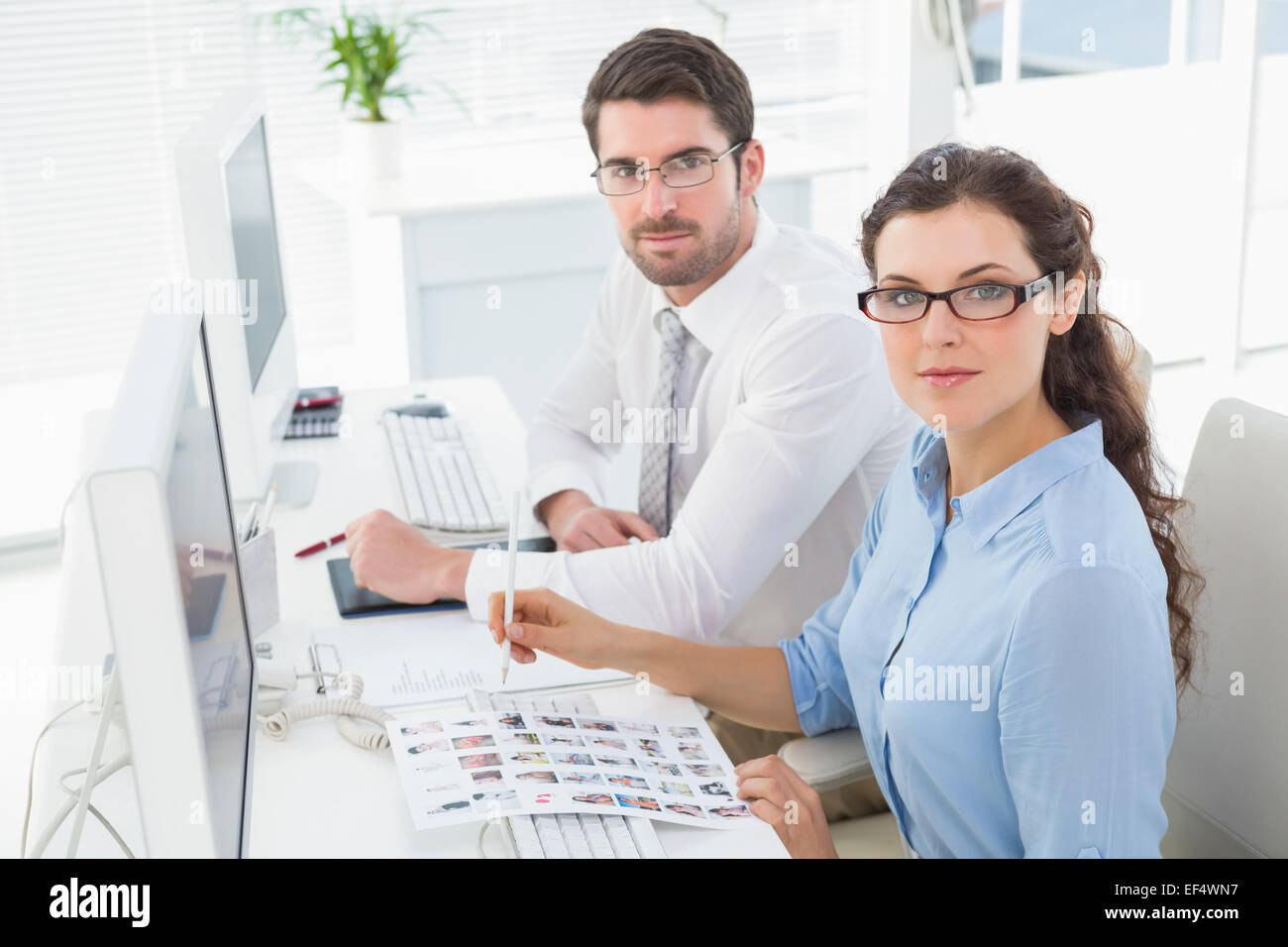 Portrait of cheerful teamwork working together Stock Photo - Alamy
