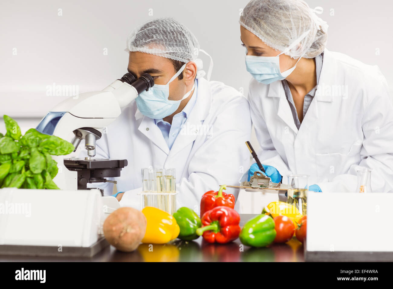 Food scientists using the microscope for research Stock Photo - Alamy