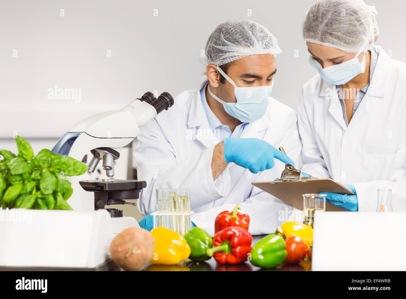 Food scientists using the microscope for research Stock Photo - Alamy
