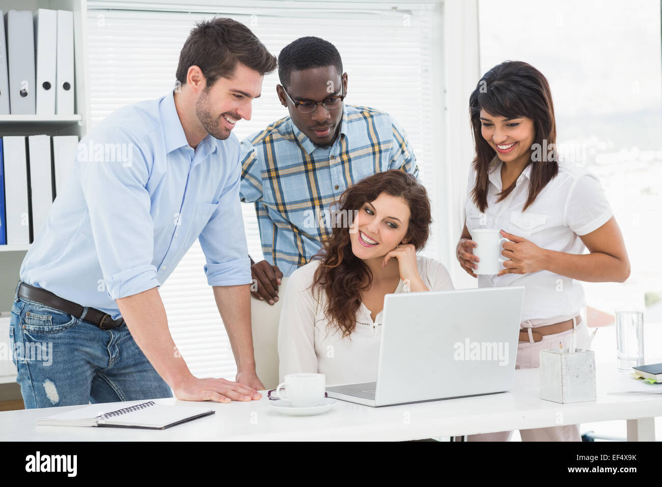 Happy teamwork using laptop together Stock Photo - Alamy
