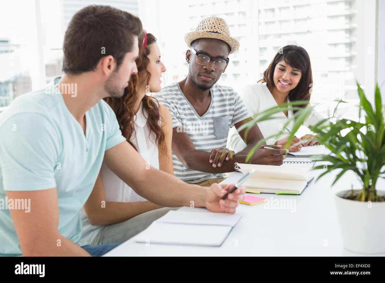 Coworkers sitting and taking notes together Stock Photo - Alamy