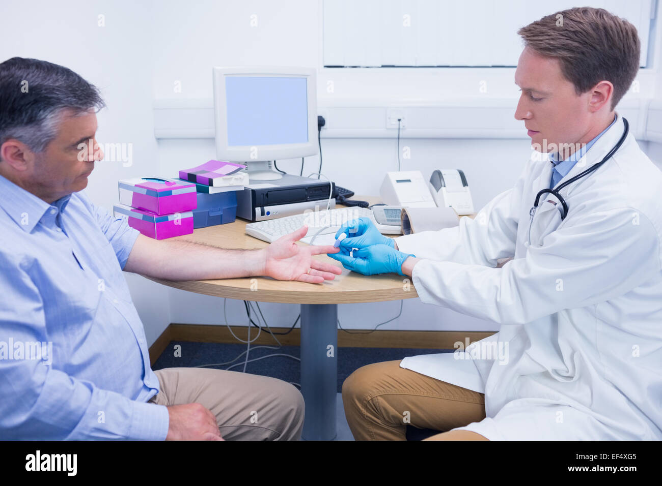 Doctor using a blood glucose meter Stock Photo - Alamy