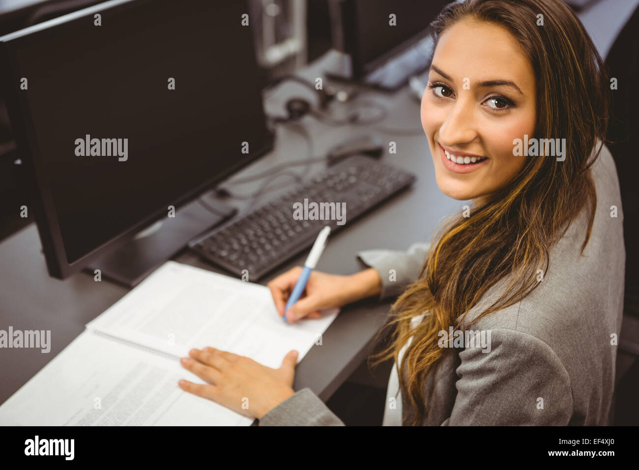 Sitting writing computer monitor technology learning education hi-res ...
