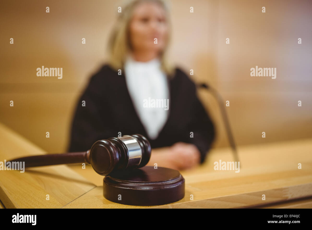 Serious judge with a gavel wearing robes Stock Photo - Alamy