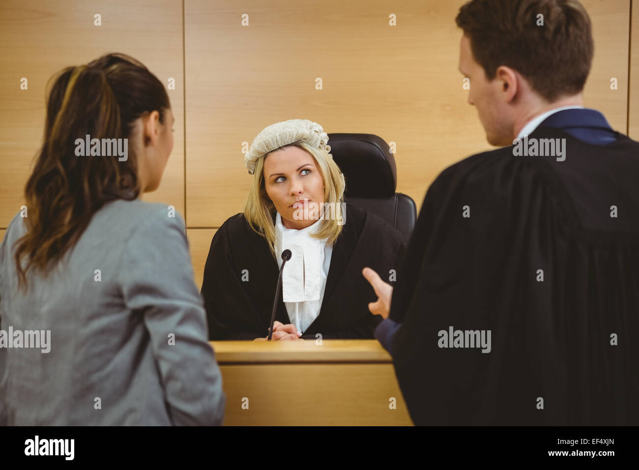 Judge wearing dress and wig listening lawyers Stock Photo - Alamy