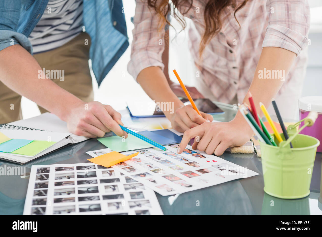 Teamwork brainstorming and editing photos together Stock Photo - Alamy