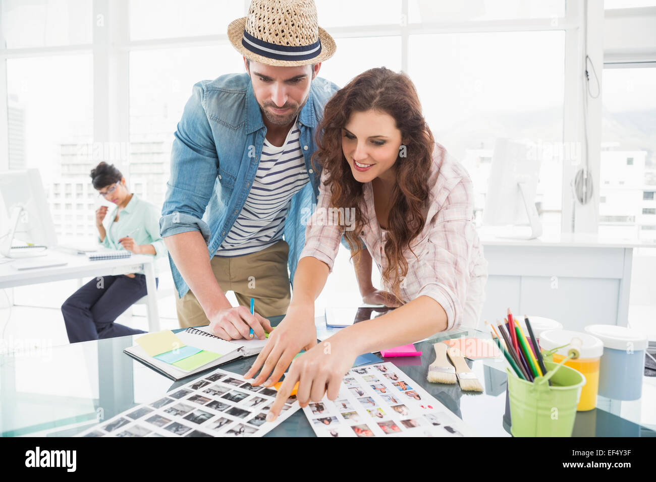 Smiling teamwork editing photos together Stock Photo - Alamy