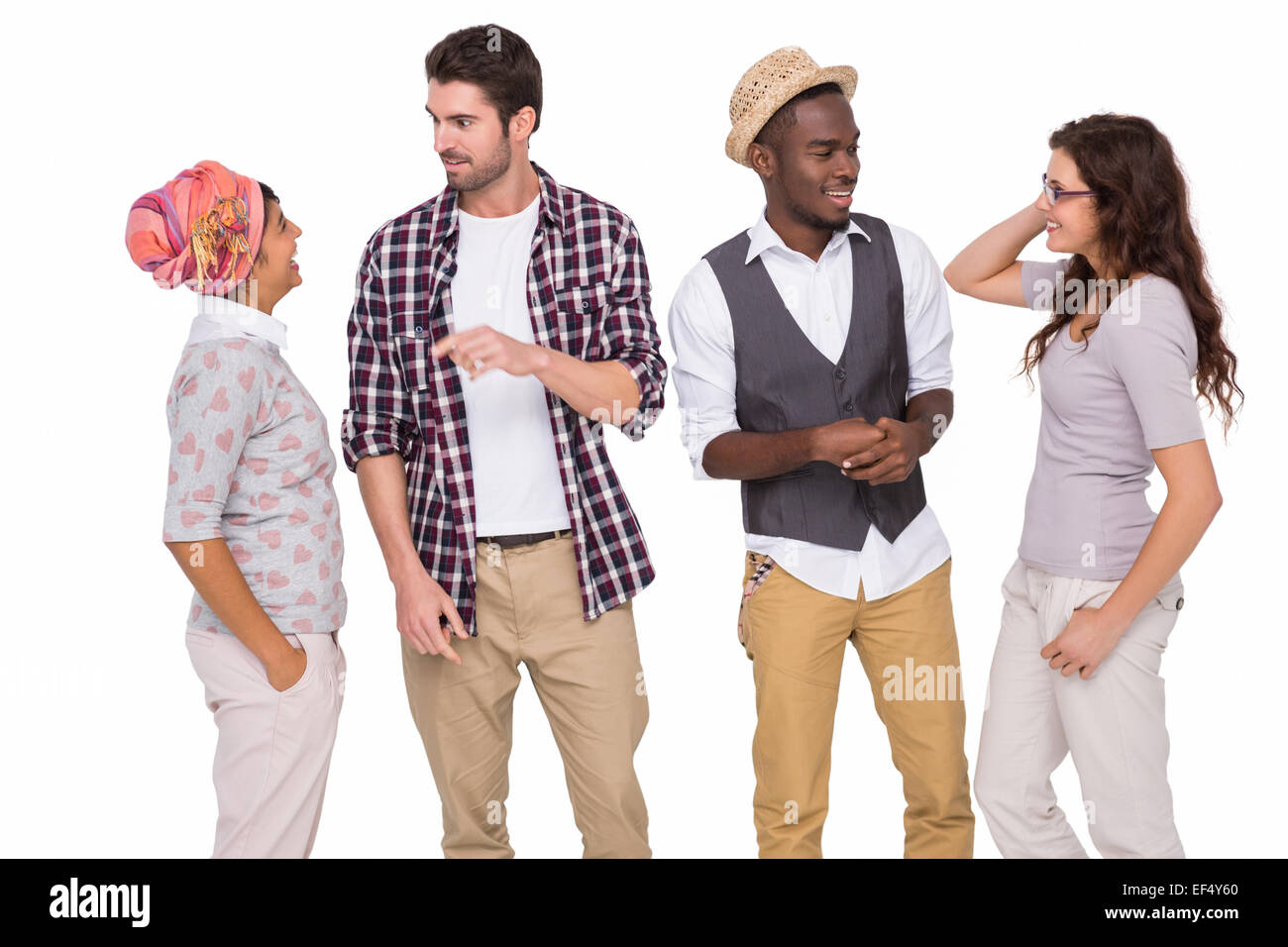 Smiling friends standing and speaking together Stock Photo - Alamy