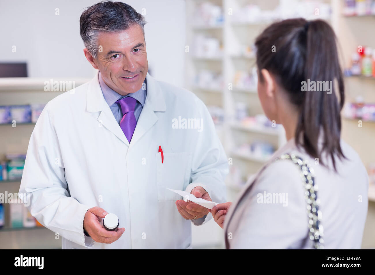 Customer handing a prescription to a pharmacist Stock Photo - Alamy