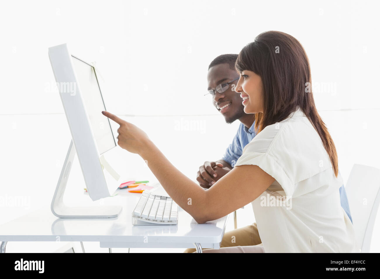 Cheerful teamwork using computer monitor Stock Photo - Alamy