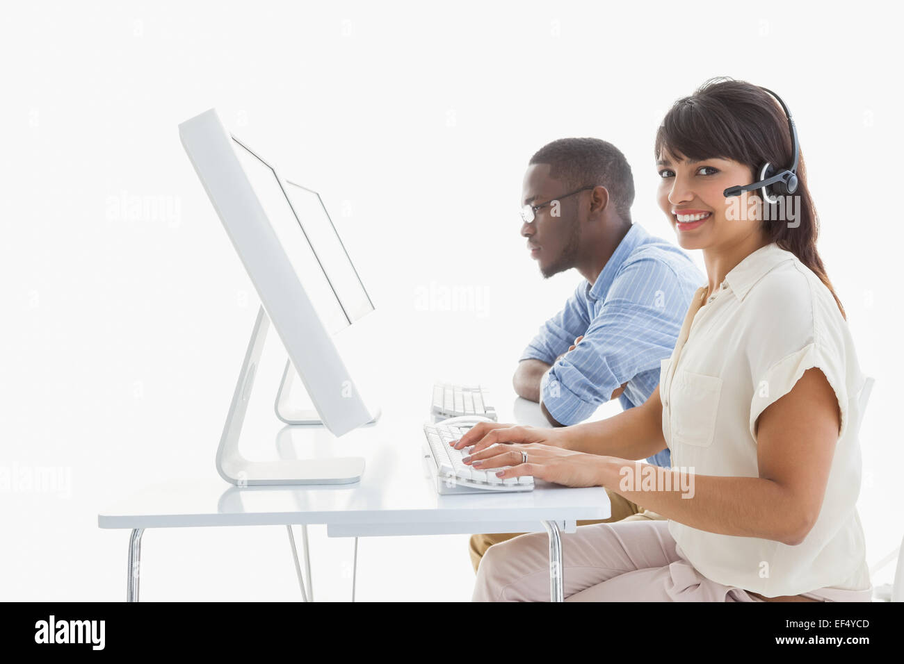 Smiling teamwork using computer and headset Stock Photo - Alamy