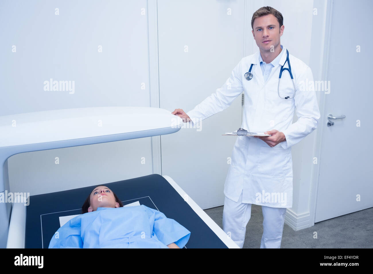 Focused doctor doing a radiography looking at camera Stock Photo - Alamy