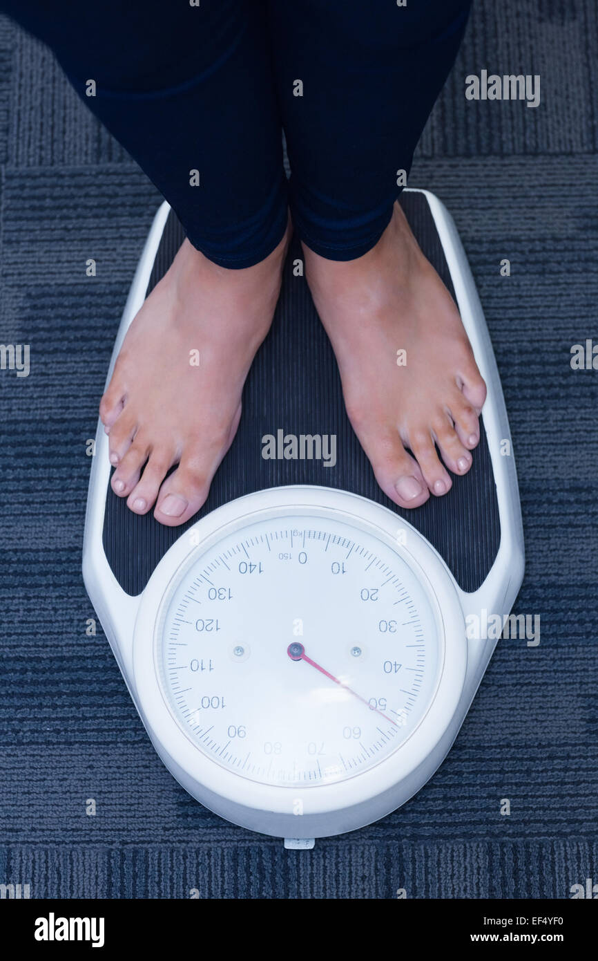 Close up of a woman standing on the scales Stock Photo - Alamy